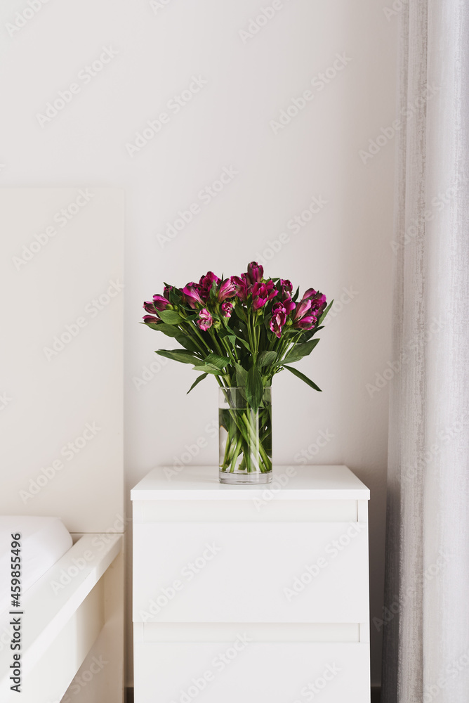 Alstroemeria flowers bouquet on a bedside table in a bedroom. Home ...