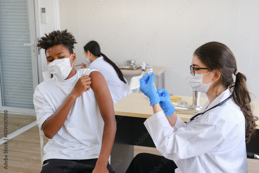 Professional nurse giving flu or antiviral vaccine to people in ...