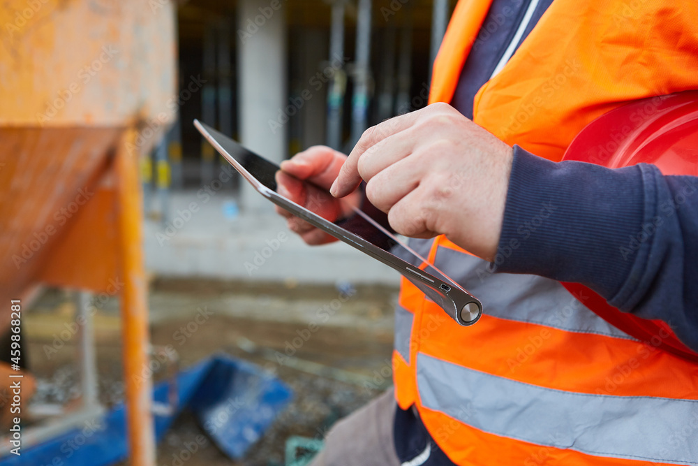 Worker with tablet computer during construction planning Stock Photo ...