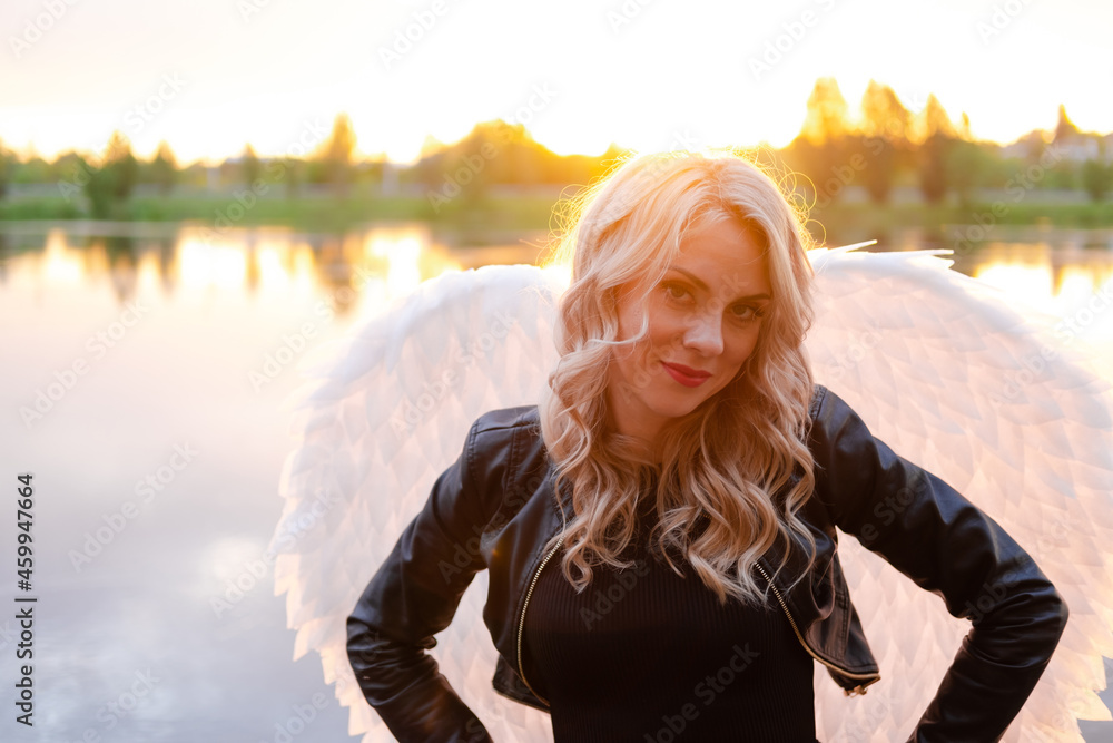 woman with white angel wings. wearing black leather clothes. fallen ...