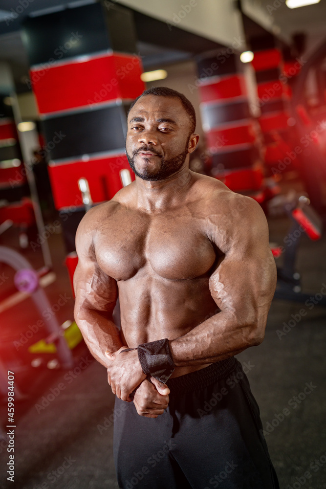 Portrait of african american male fitness trainer. Bodybuilder showing ...
