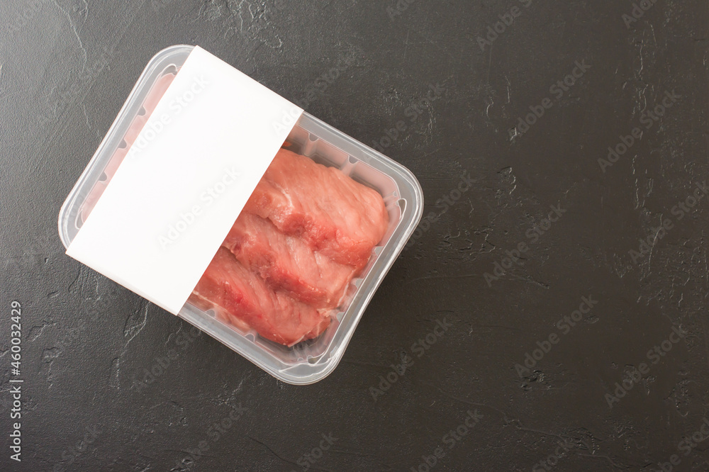 fresh beef steaks in vacuum packaging on a black background. top view ...