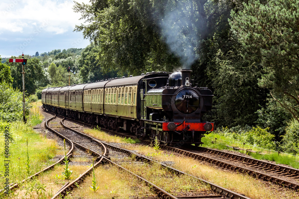 GWR Pannier tank locomotive hauling a rake of carriages Stock Photo ...