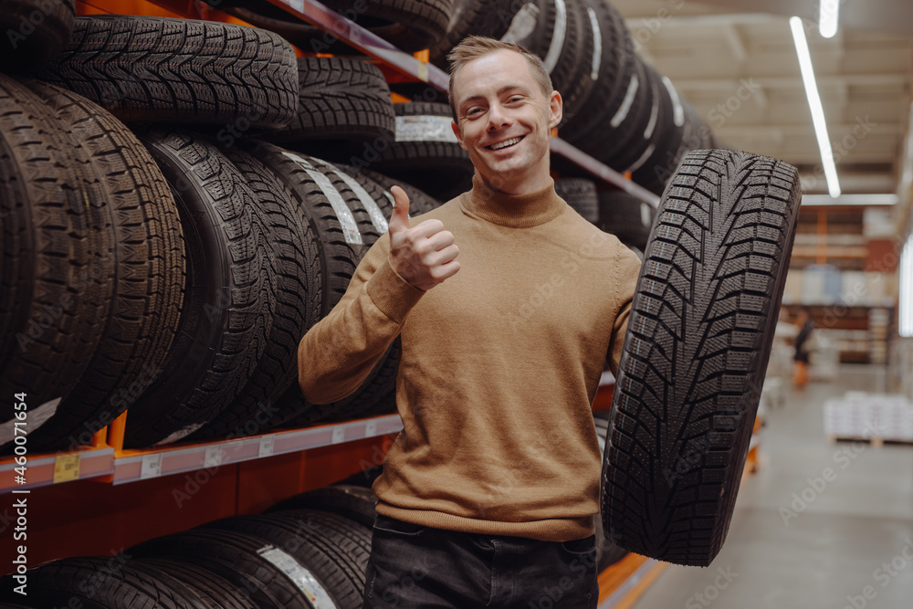 Man chooses winter car tires in the auto shop Stock-Foto | Adobe Stock
