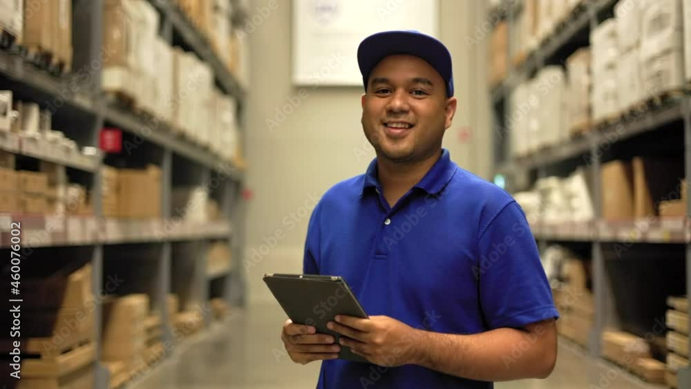 Supply chain. Young worker in blue uniform checklist manage parcel box ...