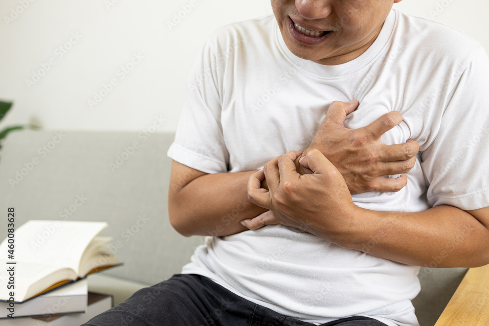 Asian middle-aged man clutching chest pain,difficulty breathing suffer ...