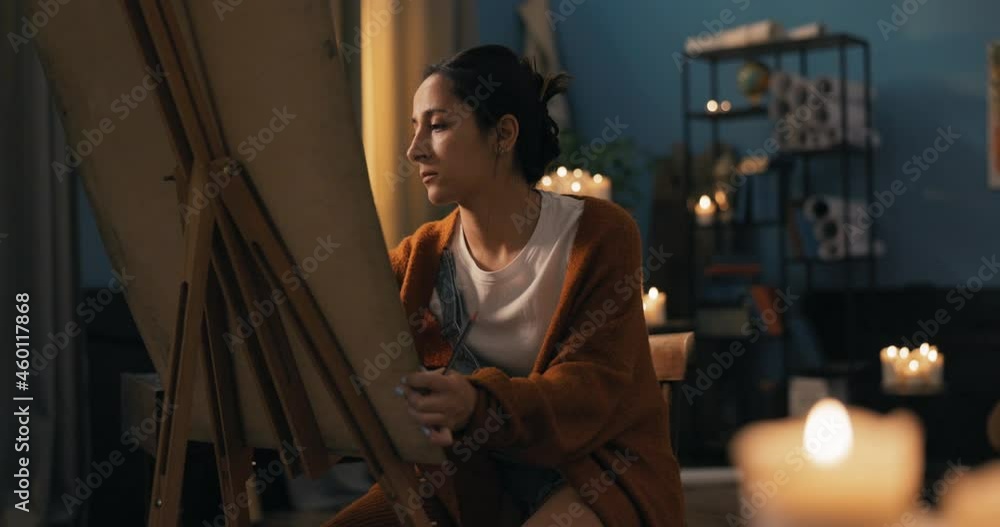 A beautiful woman dressed in curved clothes with hair pinned up sits on ...