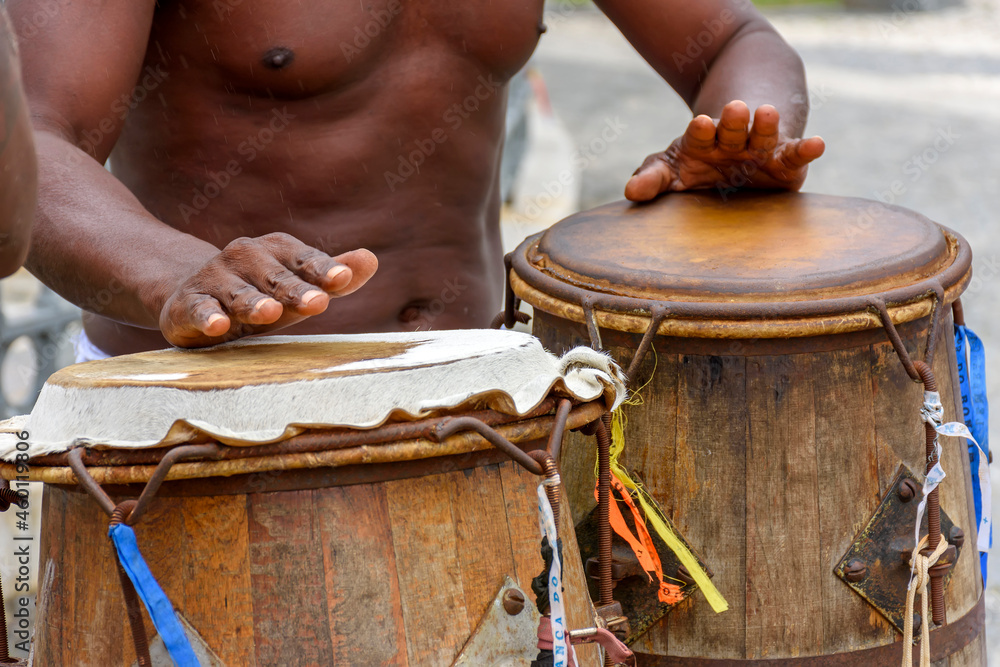 Musician playing atabaque which is a percussion instrument of African ...