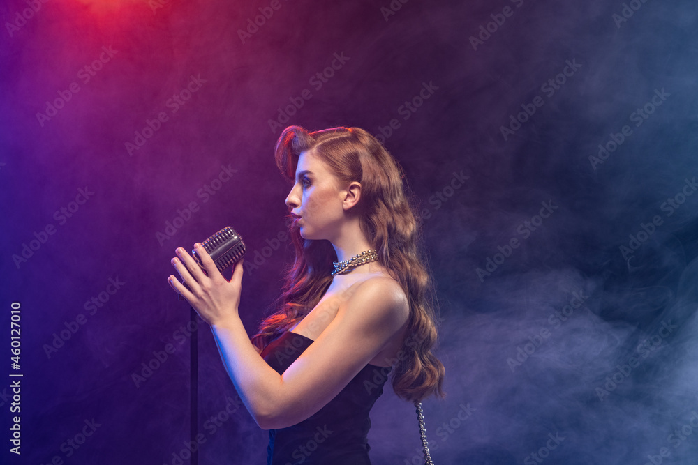 Side view portrait of red-haired attractive woman singing on stage ...