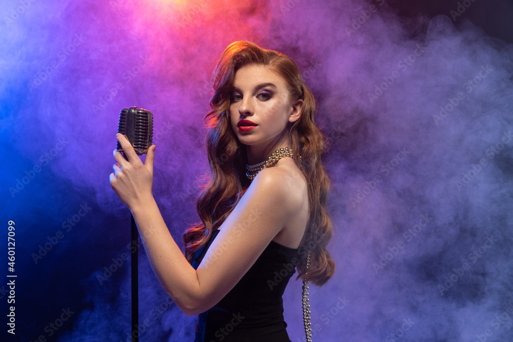 Side view portrait of beautiful female singer with microphone isolated ...