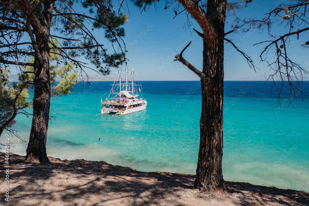 Blue sea on the Turkish coast. A boat with tourists stands near the ...