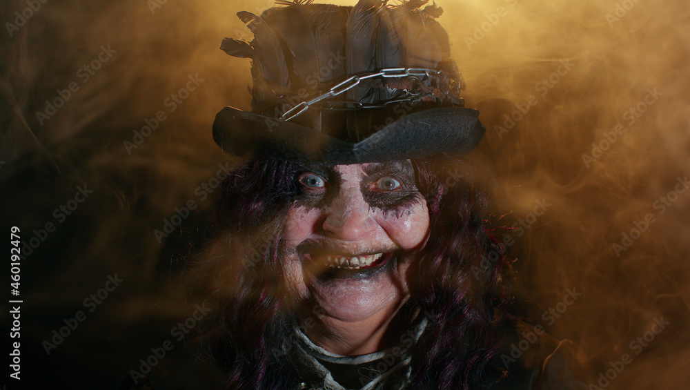 Portrait of sinister senior old mature woman in carnival costume of ...