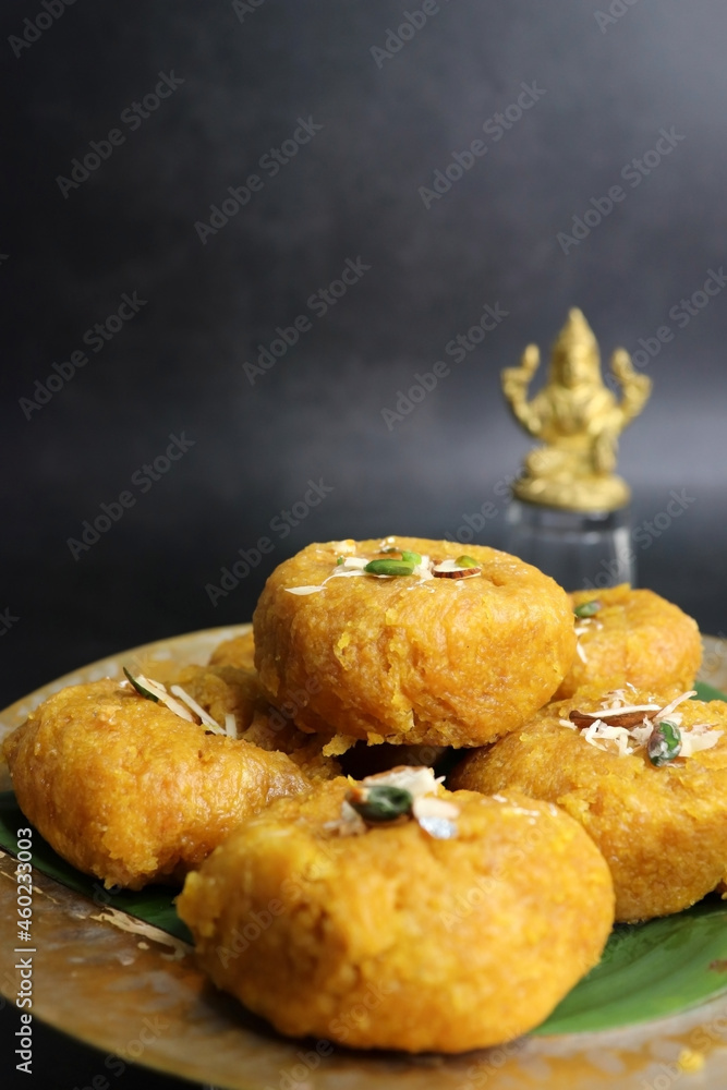 Indian traditional sweet balushahi served on a metal plate over black ...