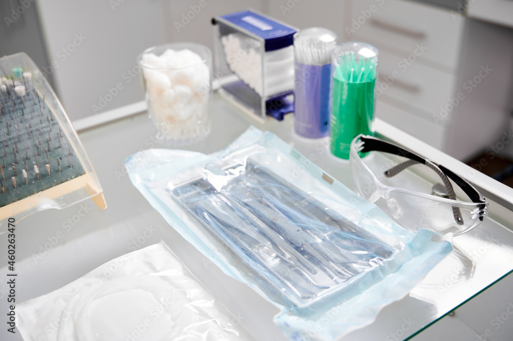 Close-up snapshot of dental instruments. Glass table in dentist office ...