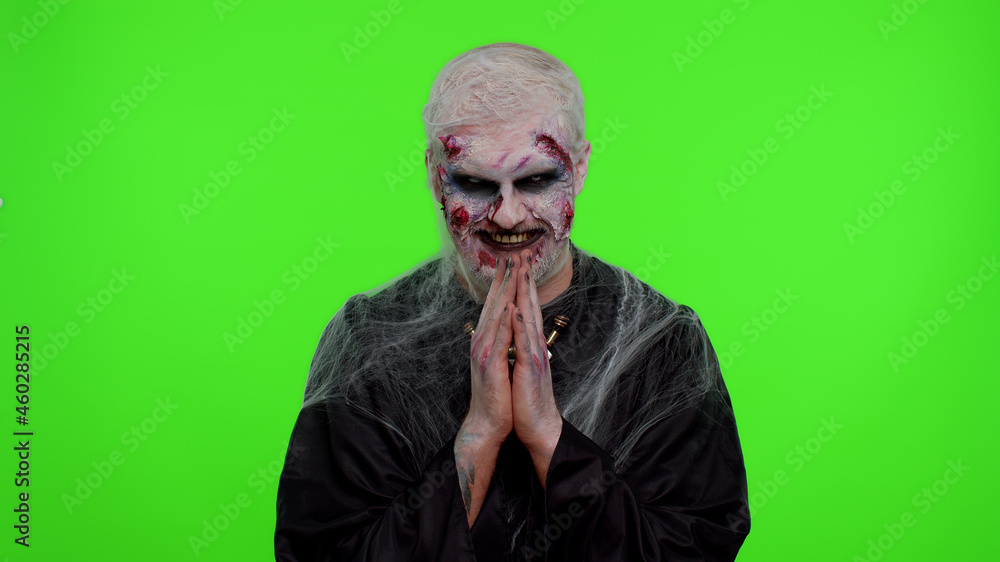 Sneaky zombie man alone with makeup with wounds scars with tricky face ...