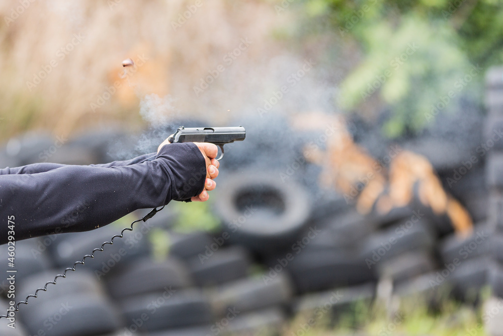 policeman firing a gun. shooting weapon. a man holds and fires a gun. a ...