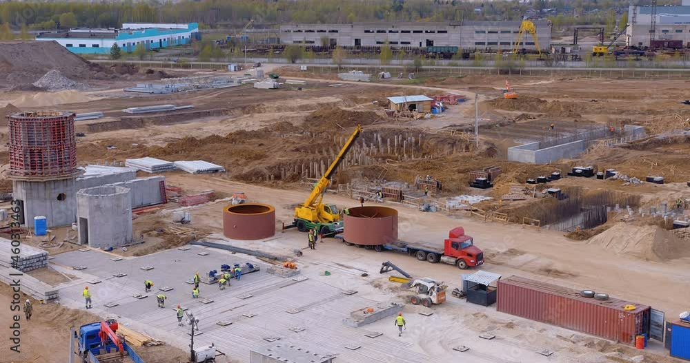 At the construction site where a new, modern plant is being built, a ...