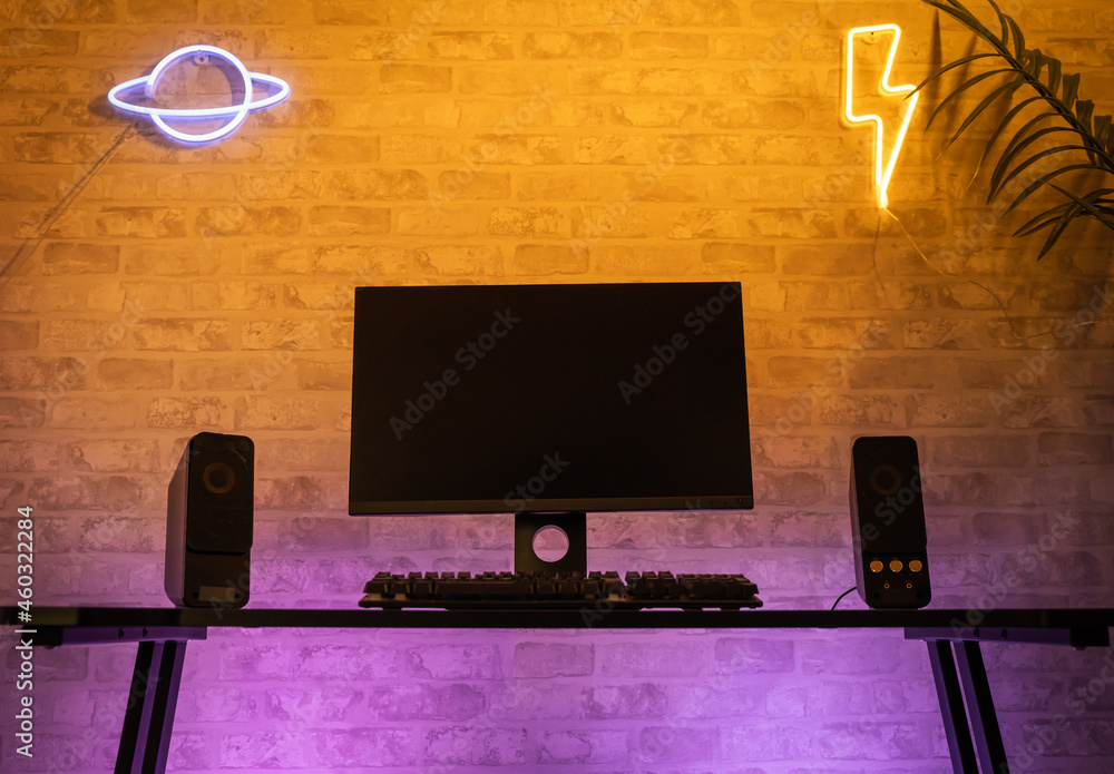 Computer gamer workspace with black screen monitor with neons and ...