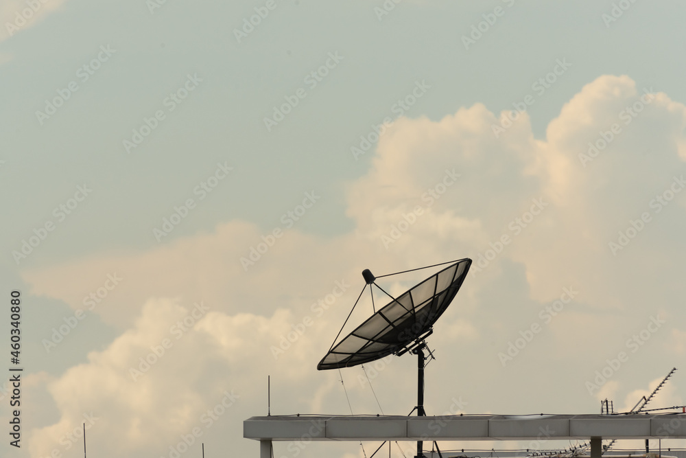 Satellite dish on building deck roof.Satellite receiver on sky and ...