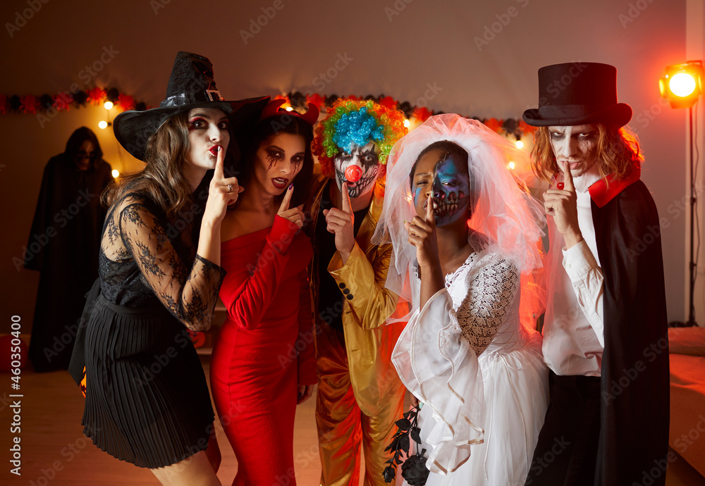 Team of male and female monsters, devils, vampires holding finger on ...