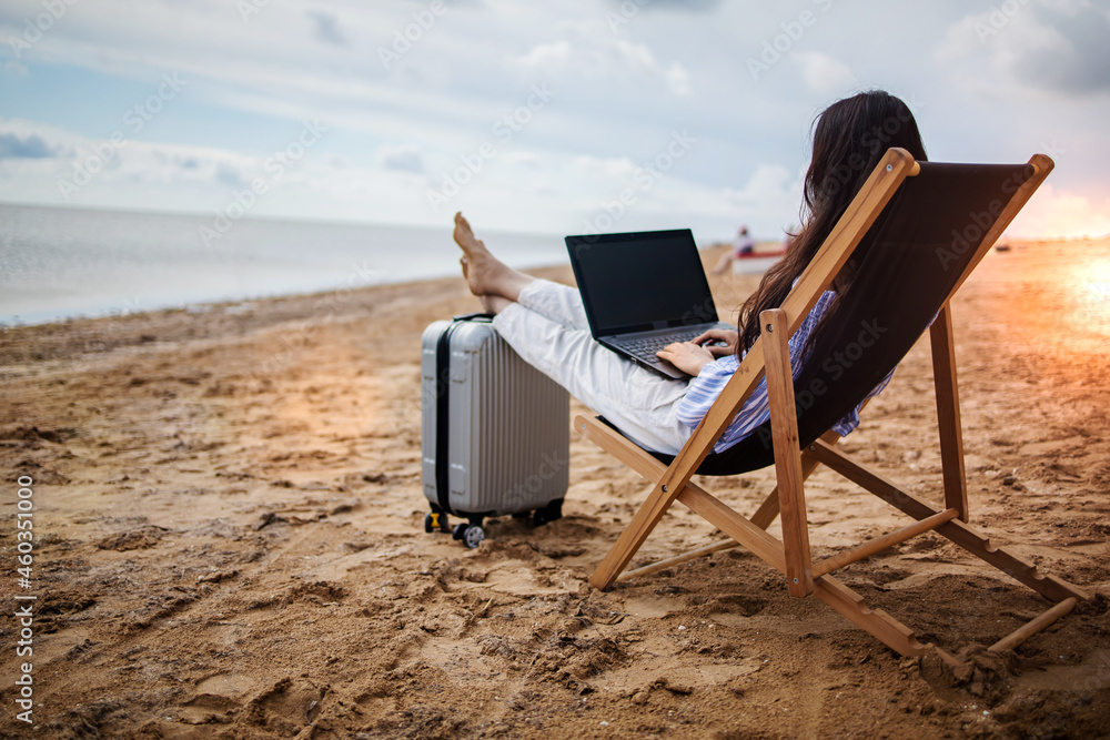 Young asian woman with tablet computer during tropical beach vacation ...