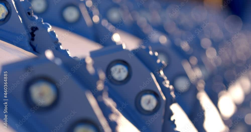 Sharp teeth on a large metal shaft in a woodworking plant, for gripping ...