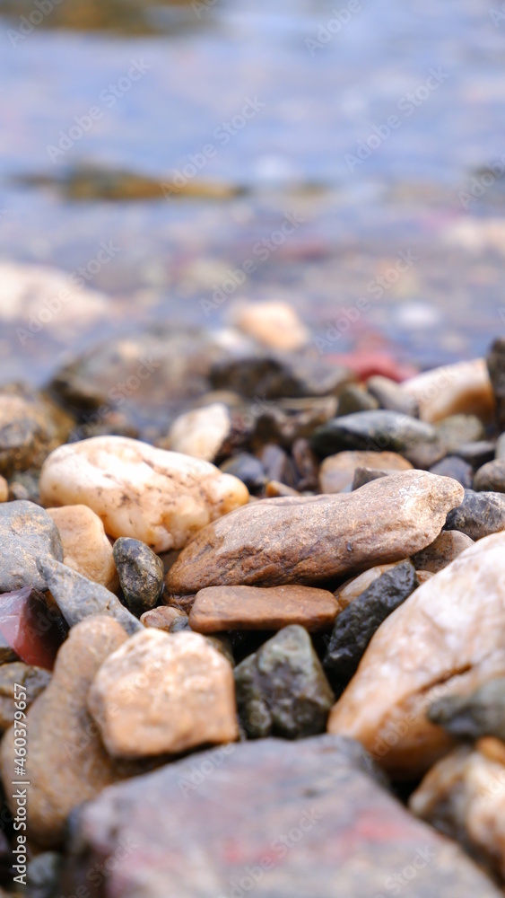 The stones lie on the banks of the river. Light stones of different ...