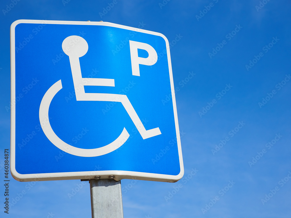Detail of a vertical pole sign marking a parking for disabled people ...