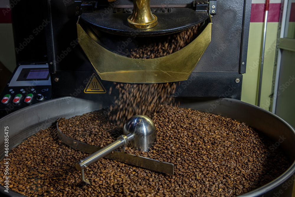 Coffee roaster machine at coffee roasting process. Mixing coffee beans ...