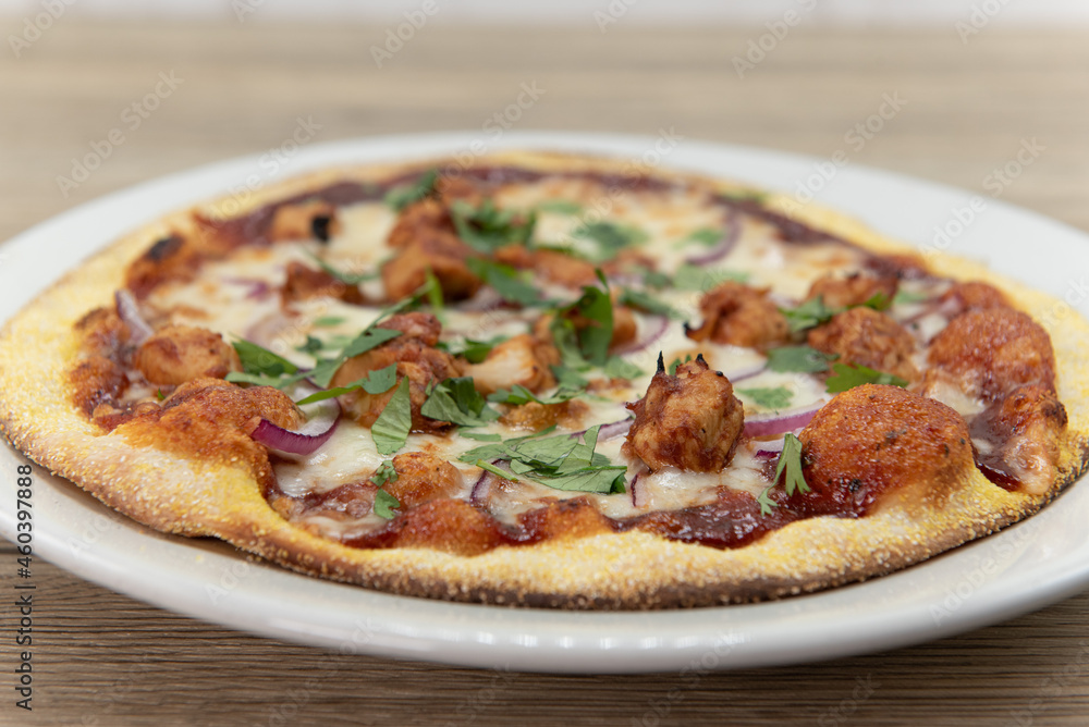 Personal sized pizza with equal meat and vegetable toppings of olives ...