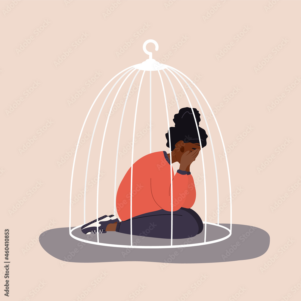 African woman locked in cage. Sad teenager sitting on floor and crying ...