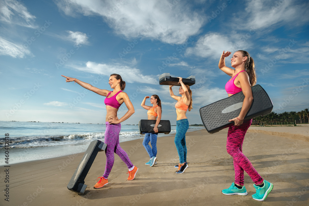 Aerobic on the beach. fitness, training, aerobics and people concept ...