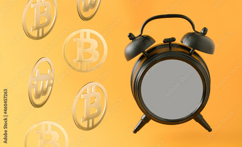 Old brown clock with blank space and bitcoins flying on a orange ...