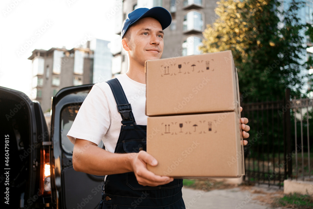 Courier service employee in uniform. The courier brought the delivery ...