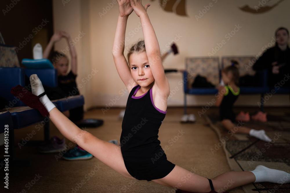 Girl gymnast stretching on training in sports camp Stock Photo | Adobe ...