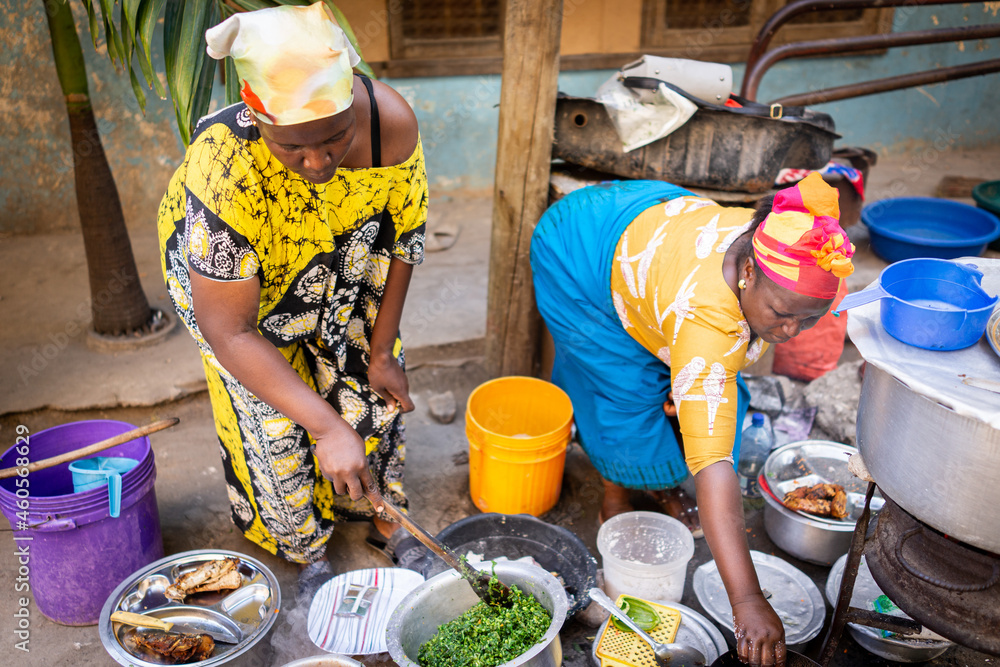 African woman cooking traditional food at street Stock Photo | Adobe Stock