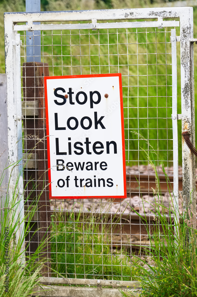 Stop look listen safety road sign at railway train station danger ...