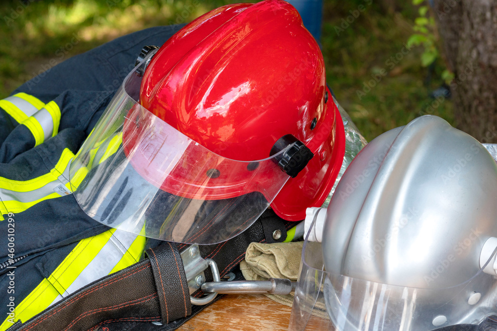Firefighter uniform with red helmet. Close-up image of a red helmet of ...