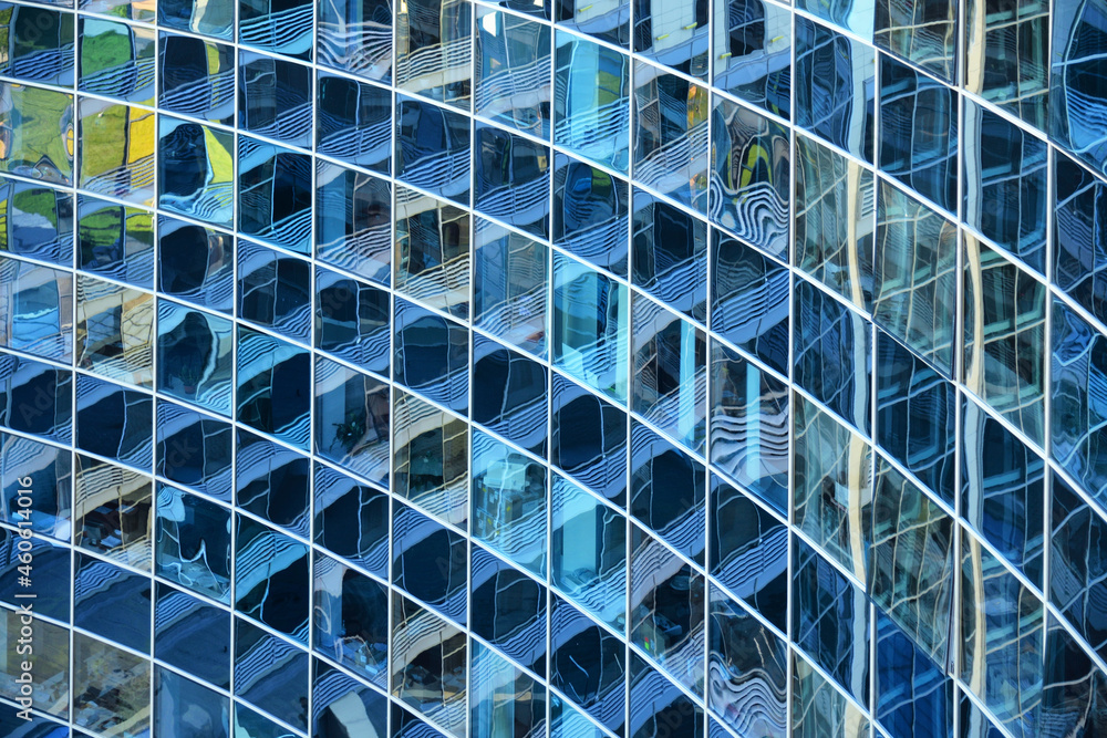 Curved glass facade of a modern office building with geometric pattern ...