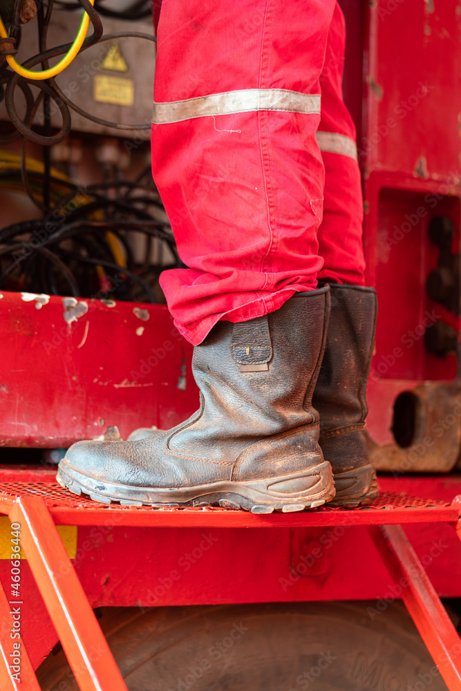 Action of a worker who wearied with fully PPE such as safety boots and ...