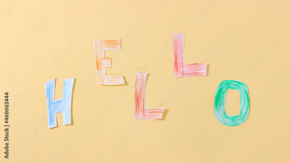 Colored letters made of paper are formed into the word HELLO. The ...
