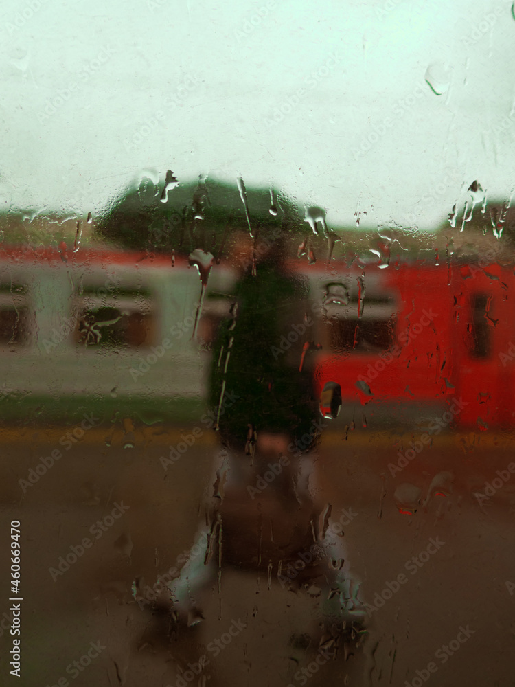 Rainy weather on the day of departure by commuter train. The man on the ...