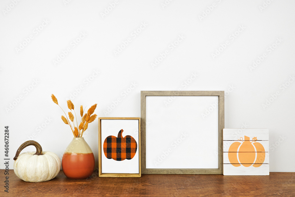 Autumn mock up. Wood frame, wooden signs, pumpkins and fall branches on ...