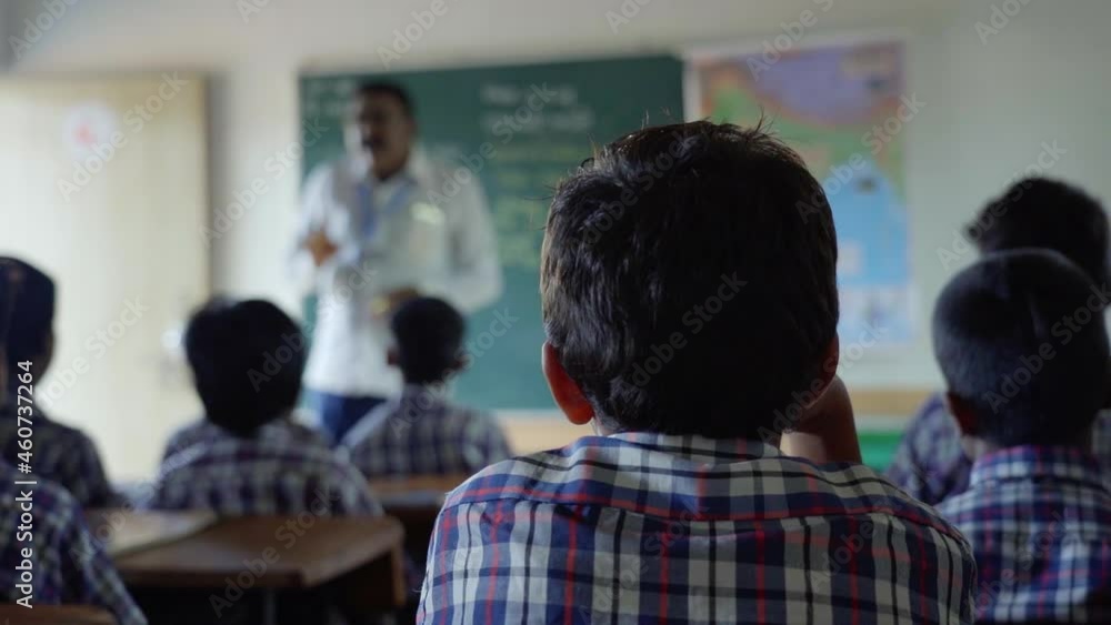 Indian tribal village boy in classroom listening to Male teacher ...