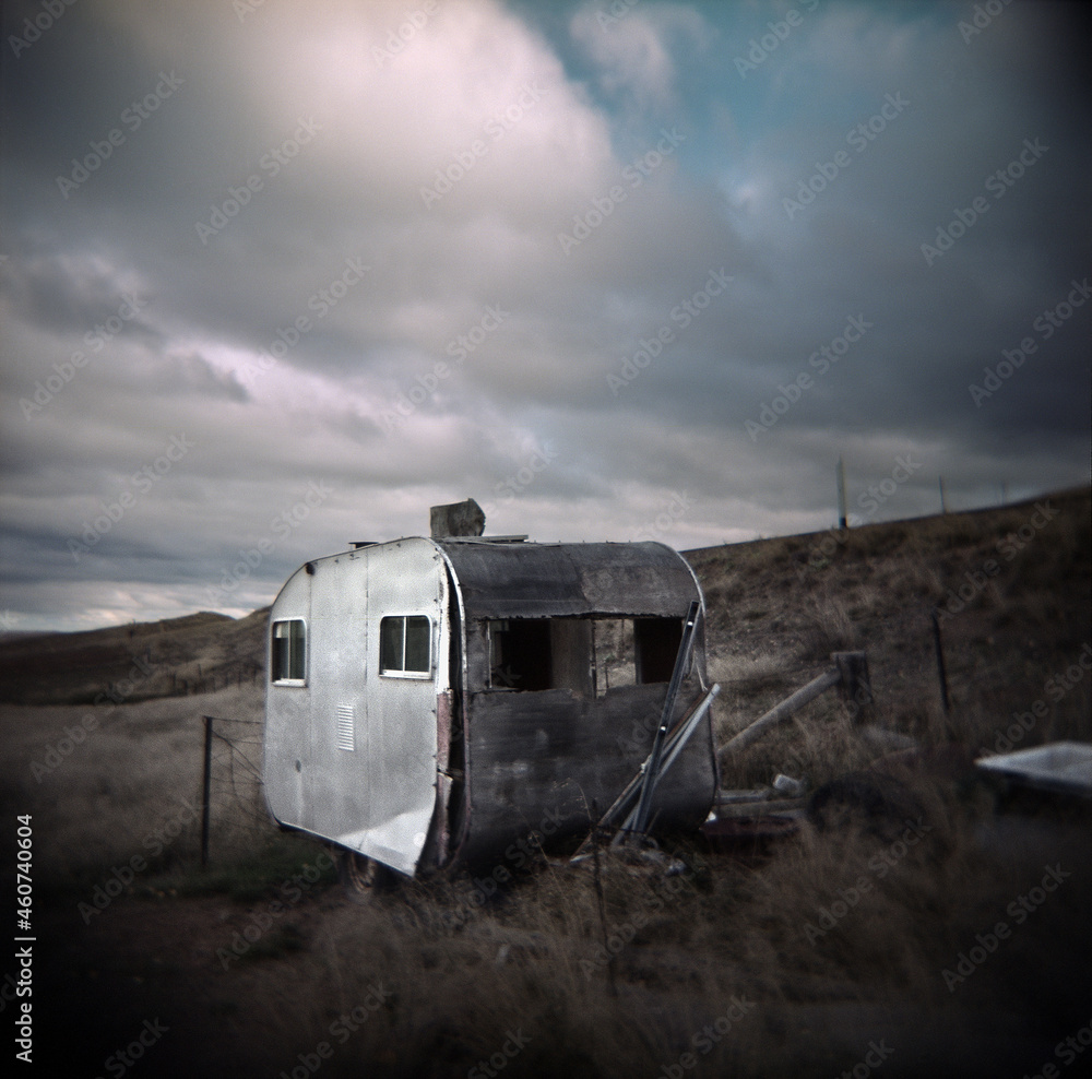 Old derelict caravan sitting abandoned in a rural paddock Stock Photo ...