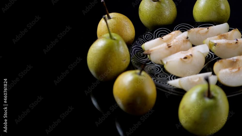 Pan shot of tasty and crunchy green pears cut in half served on a ...