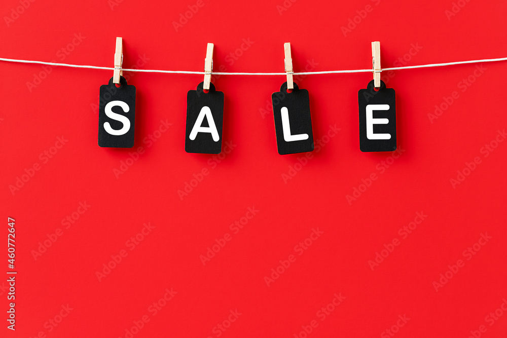 Red background for sales with black labels hanging on clothespins Stock ...