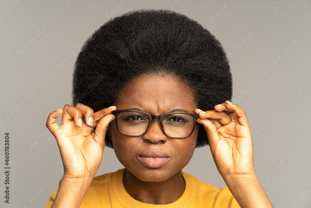 Young african woman with poor eyesight squinting eyes looking through ...