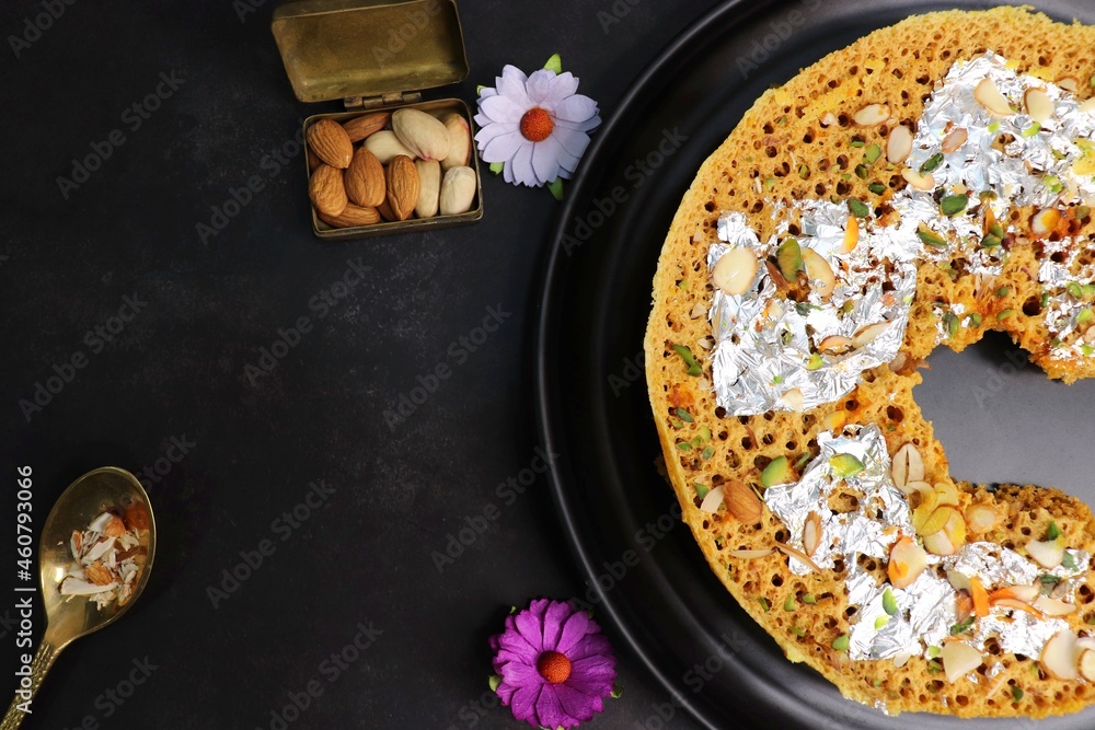 Rajasthani Ghevar. Ghewar is an Indian crunchy sweet dish made using ...