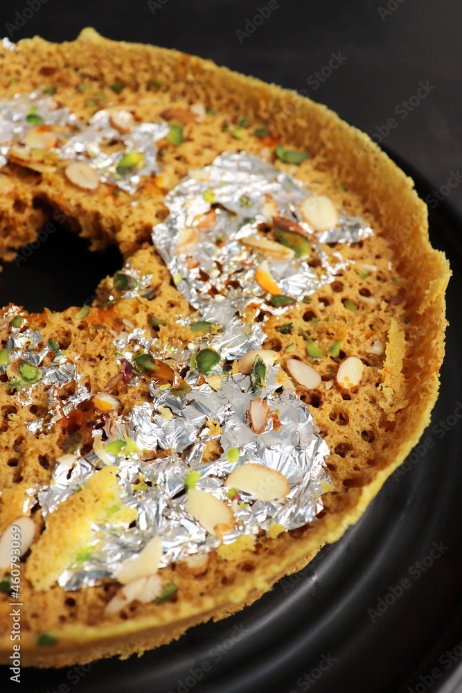 Rajasthani Ghevar. Ghewar is an Indian crunchy sweet dish made using ...